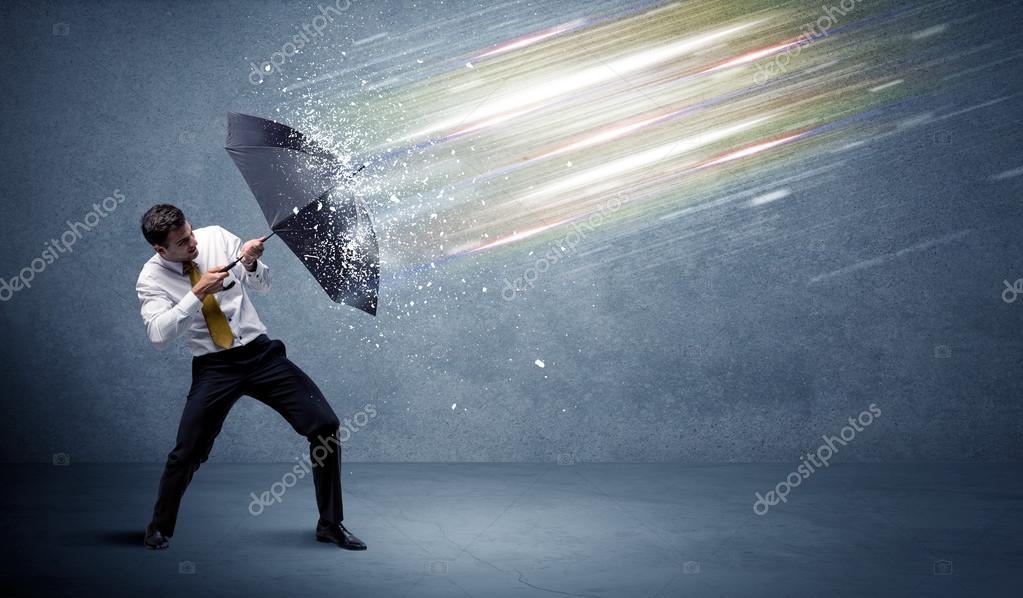 Business man defending light beams with umbrella concept Stock Photo by ...