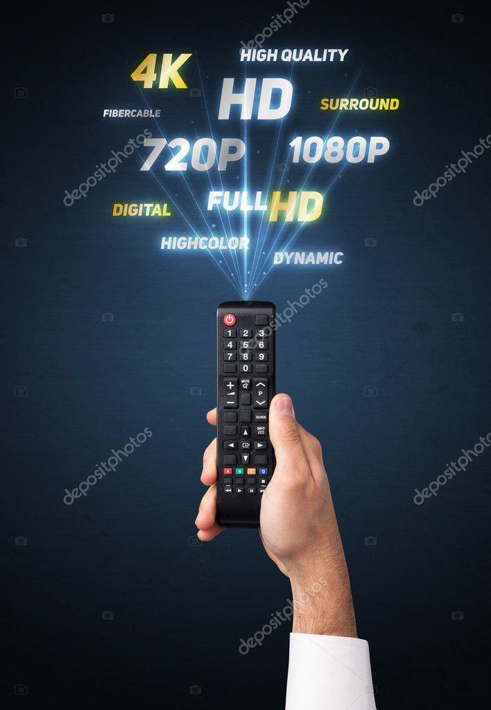 Hand with remote control and multimedia properties — Stock Photo ...