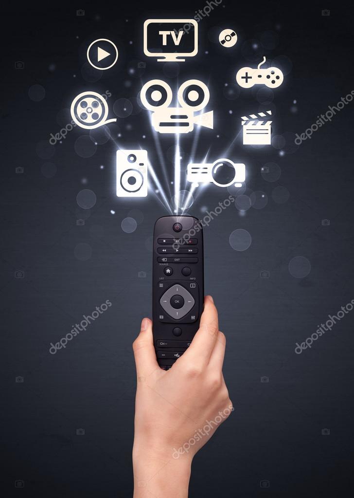 Hand with remote control and media icons — Stock Photo © ra2studio ...