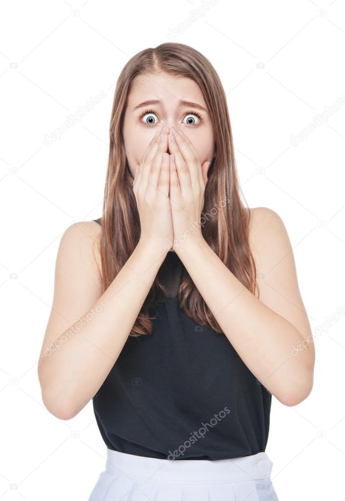 Young scared teenage girl covering her mouth with hand isolated Stock ...