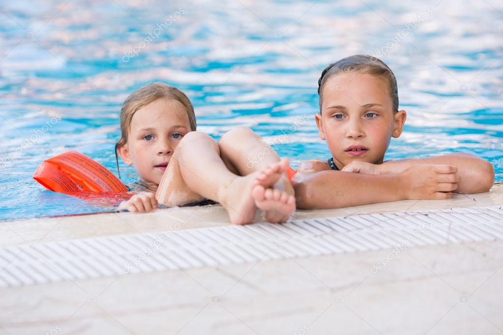 Two cute little girls in swimming pool — Stock Photo © Len44ik #72664255