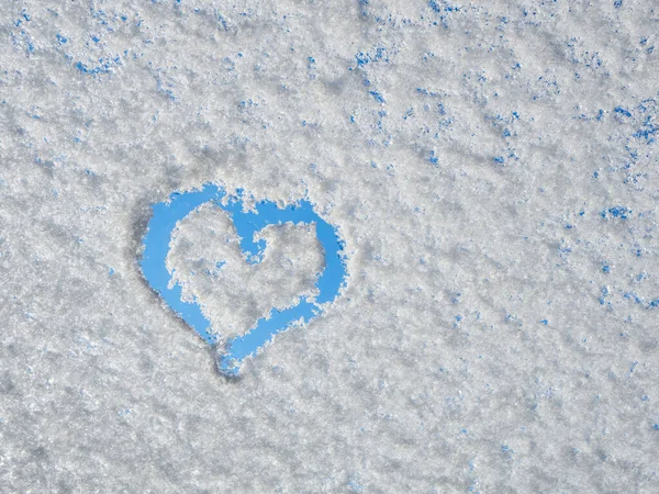 Heart shape painted by finger on frozen window. Heart shape drawn on a ...