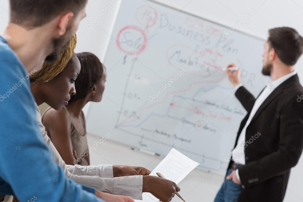 Man presenting charts Stock Photo by ©HASLOO 64447689