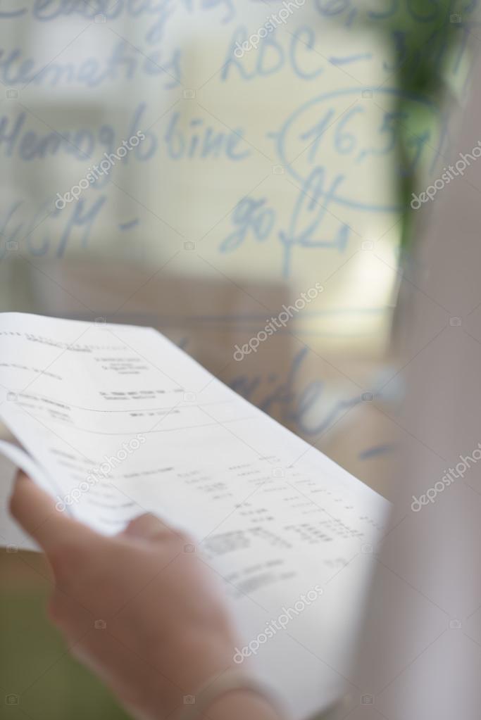 Doctor writing on transparent board — Stock Photo © HASLOO #77235800