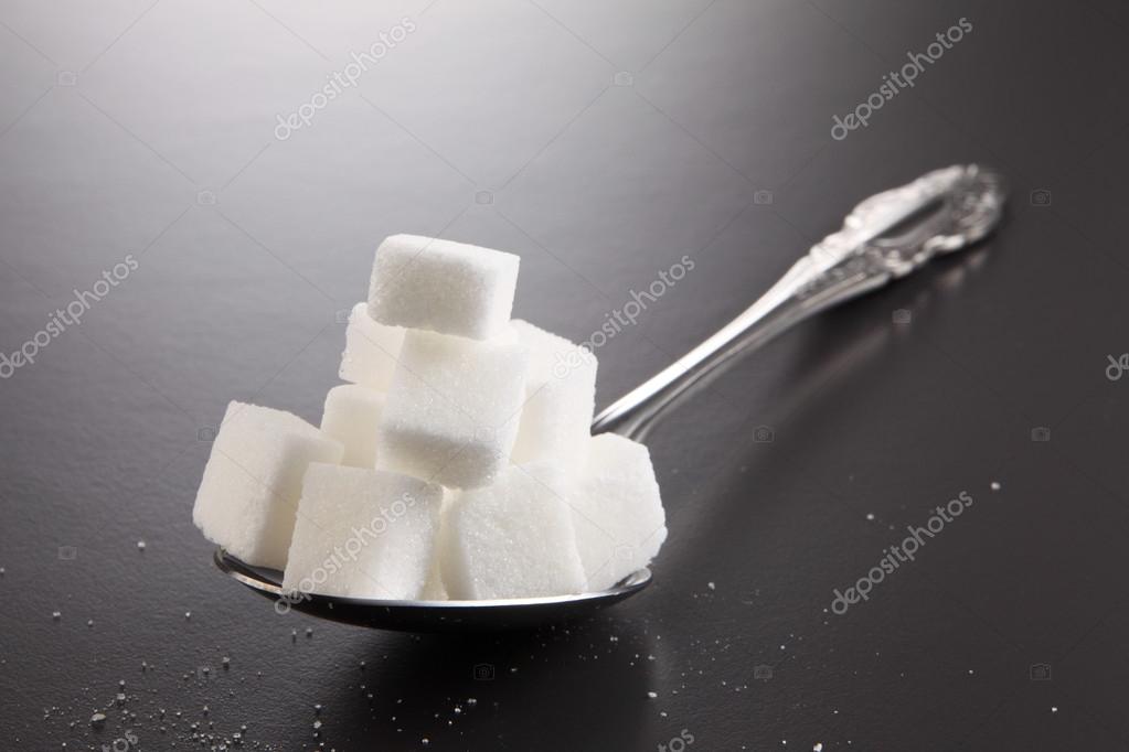 Giant spoon with cube sugar — Stock Photo © eskaylim #93167444