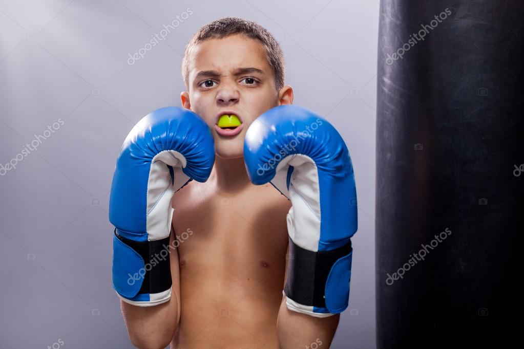 Angry young child with boxing gloves Stock Photo by ©pyotr021 96885326