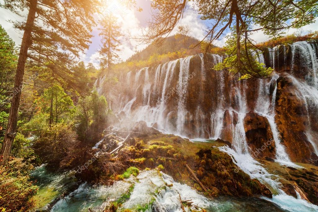 The Nuo Ri Lang Waterfall (Nuorilang) among fall woods Stock Photo by ...