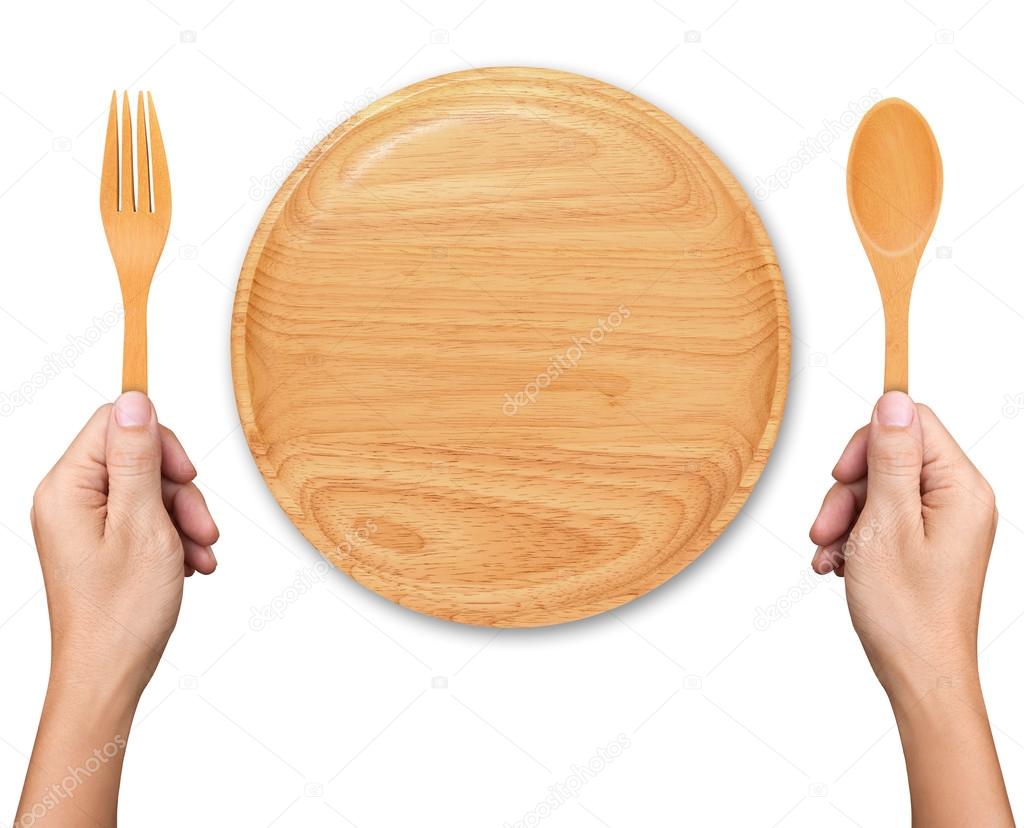 Hands hold spoon and fork with Empty wood plate on white Stock Photo by ...