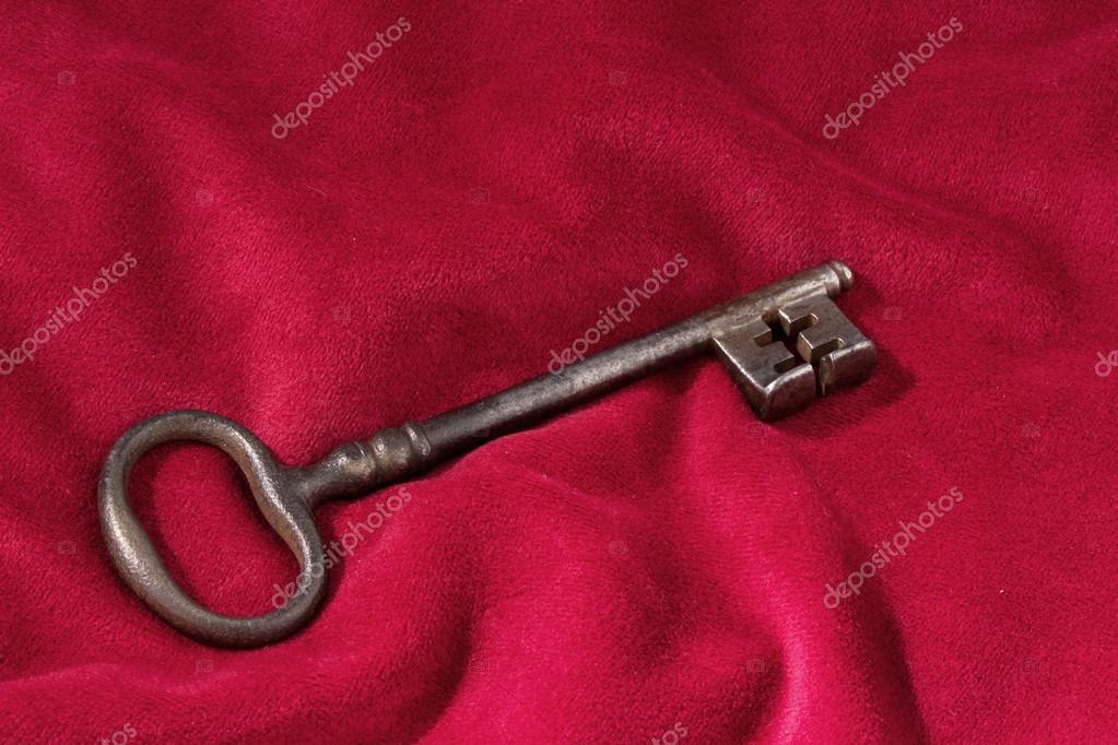 Key on a red velvet cushion — Stock Photo © ginasanders #58652999