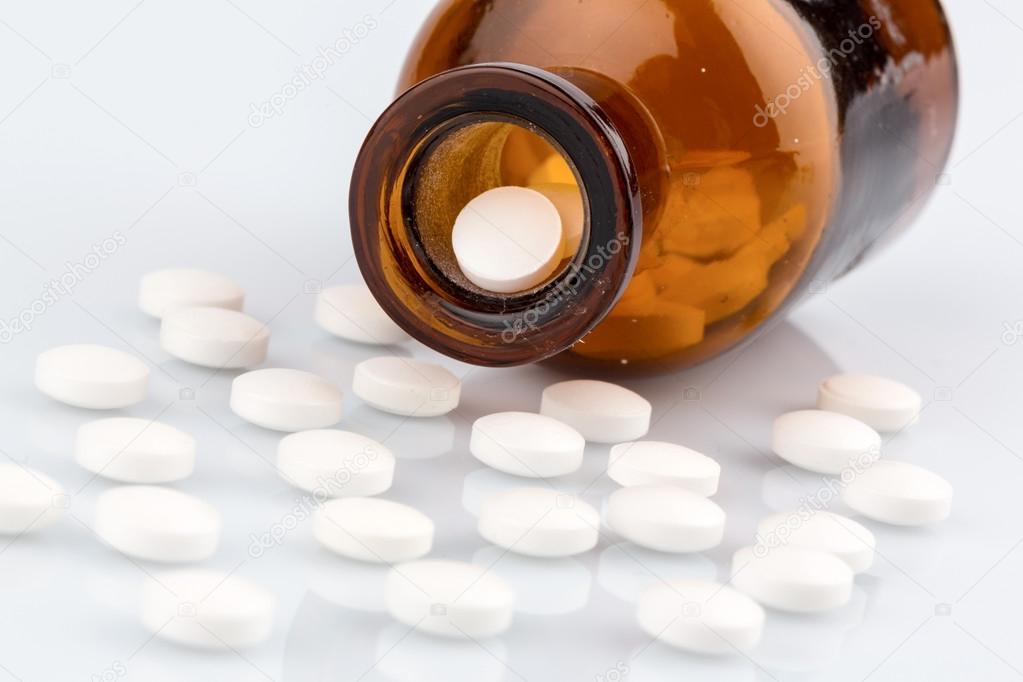 Many tablets with container Stock Photo by ©ginasanders 72815021
