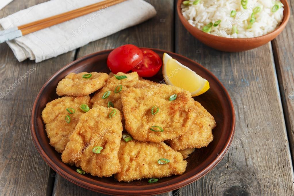 Roasted schnitzel chop escalope with lemon tomato rice Stock Photo by ...