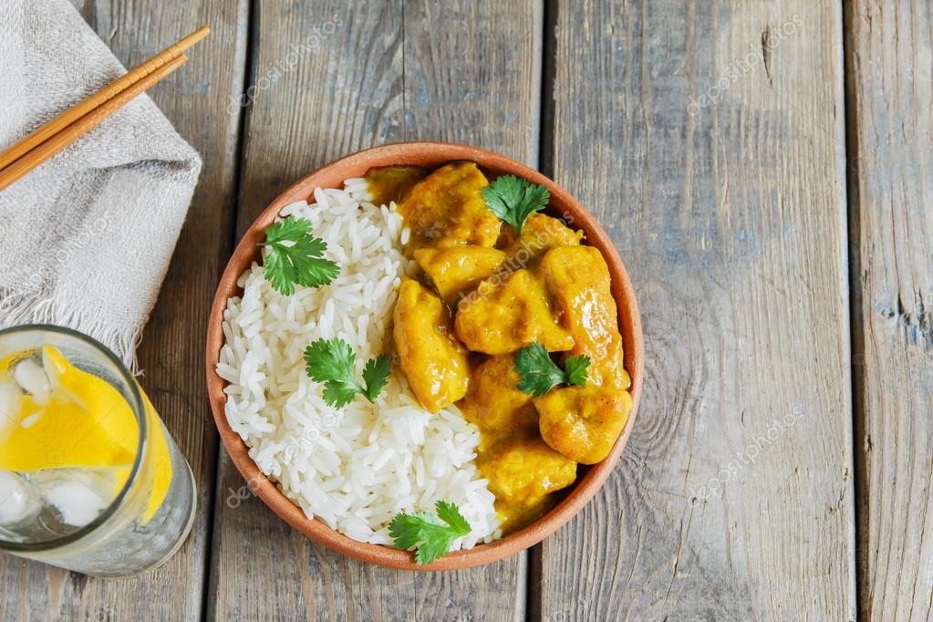 Chicken curry with rice on a wooden surface ⬇ Stock Photo, Image by ...
