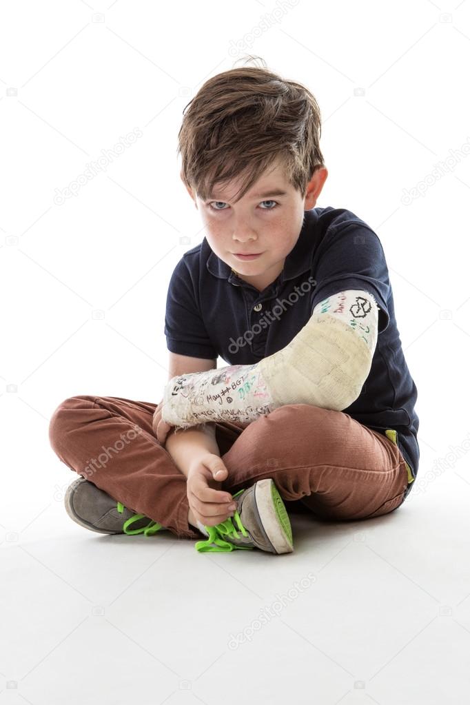 Sad boy with broken arm Stock Photo by ©jayfish 93872490
