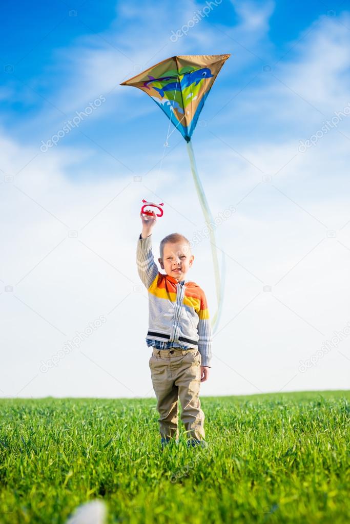 Young boy playing with his kite in a green field. — Stock Photo ...