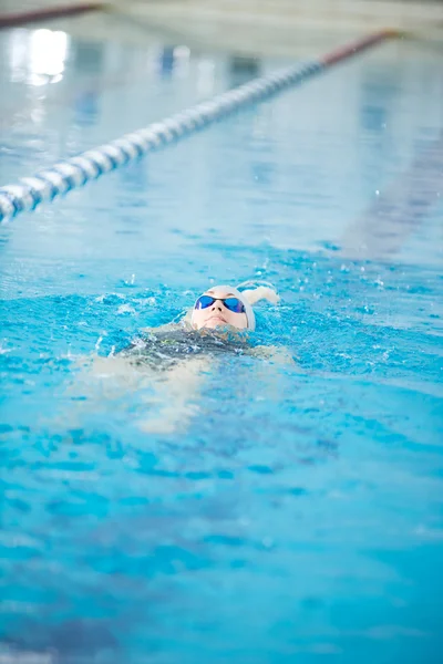 Girl swimming back crawl stroke style Stock Photo by ©markin 37223409