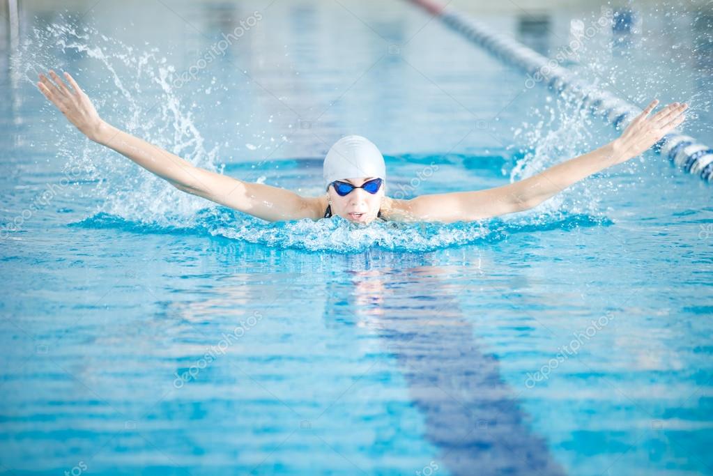 Girl swimming in butterfly stroke style Stock Photo by ©markin 52924337