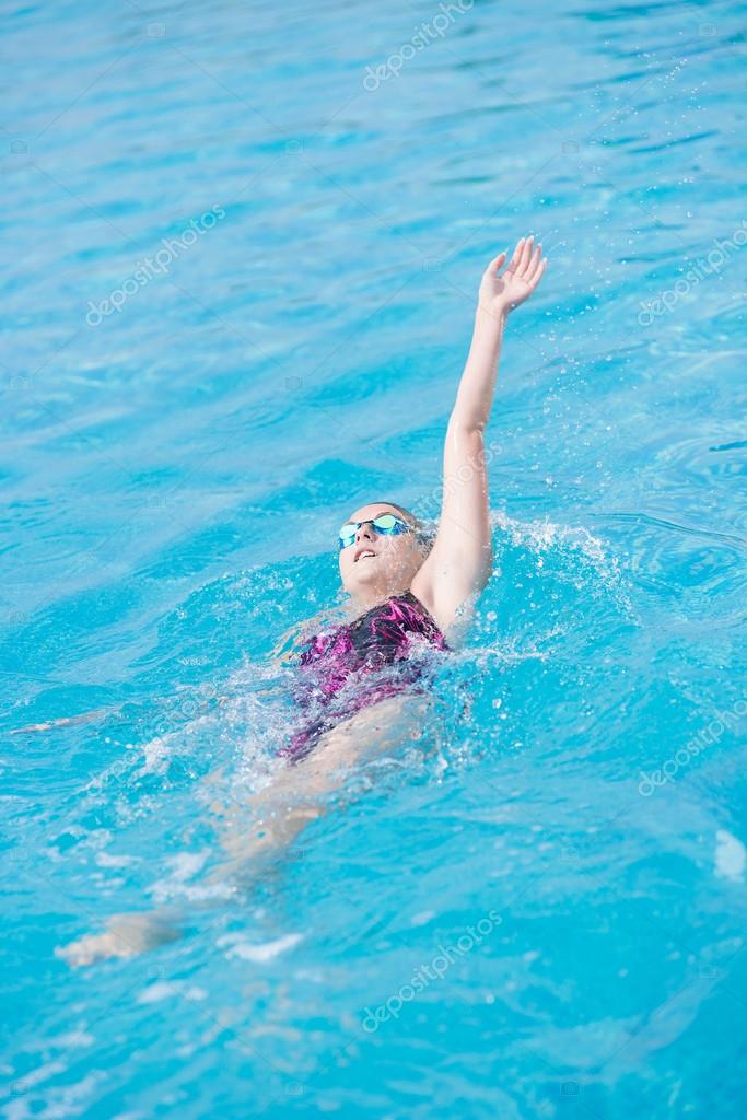 Woman swimming back crawl style Stock Photo by ©markin 52938027