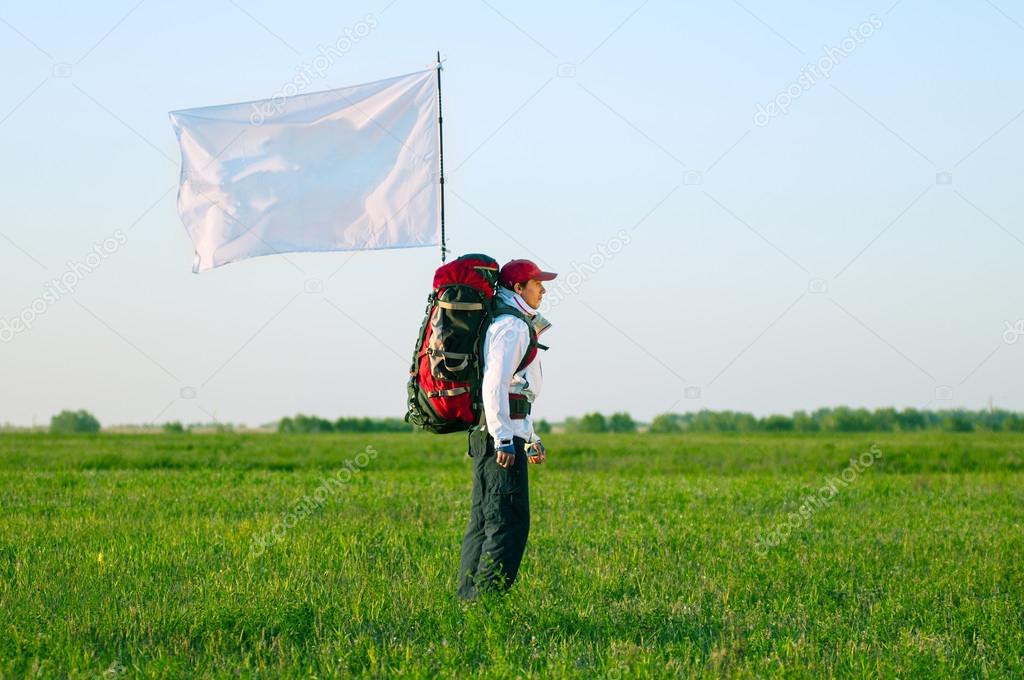 Hiker with backpack and flag — Stock Photo © markin #66384099