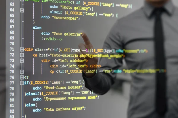 Man pointing on virtual screen with website programming code - Stock ...