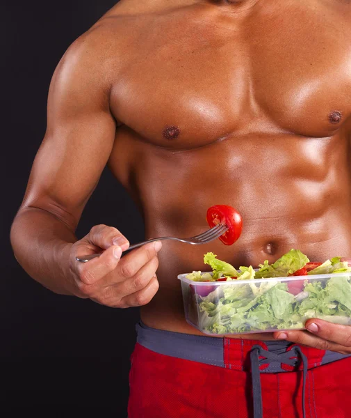 Muscular man eating healthy food — Stock Photo © aallm #58918045