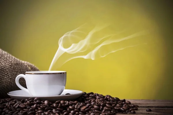 Cup of hot coffee about the ferry and grains of coffee on grunge ...