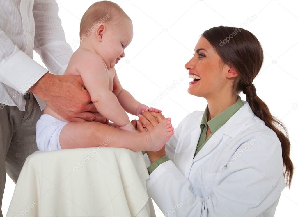 Happy pediatrician checking baby being held by father — Stock Photo ...