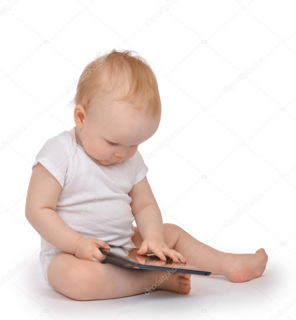 Infant child baby toddler sitting and typing digital tablet mobi Stock ...