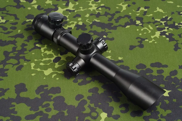 Sniper scope on camouflage Stock Photo by ©zim90 80431042