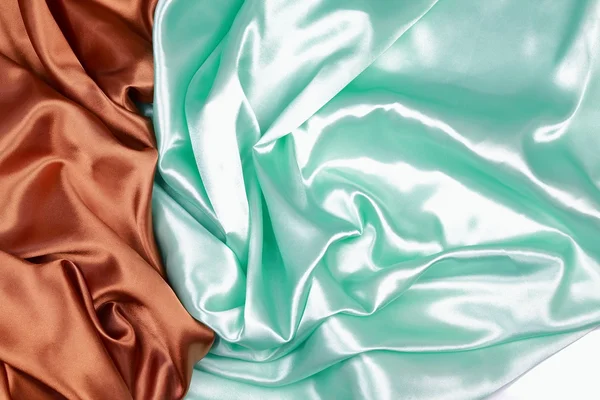Brown and light green silk satin cloth of wavy folds texture bac ...