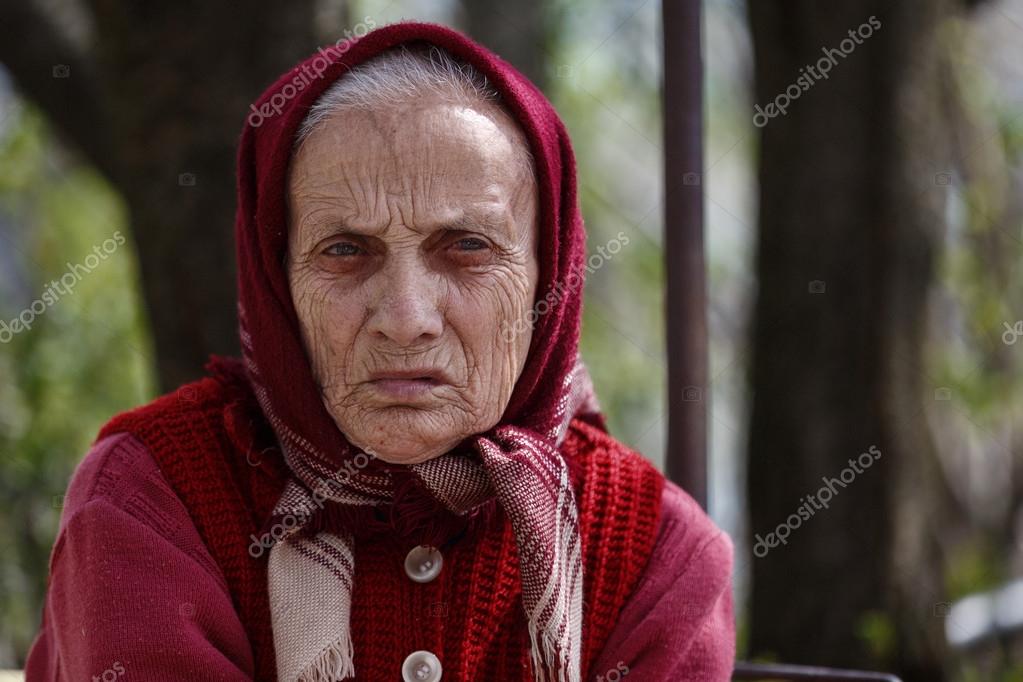Old rural woman with kerchief outdoor — Stock Photo © czamfir #70483065