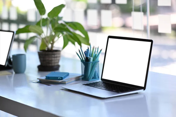 Freelancer or designer workspace with a laptop computer with blank ...