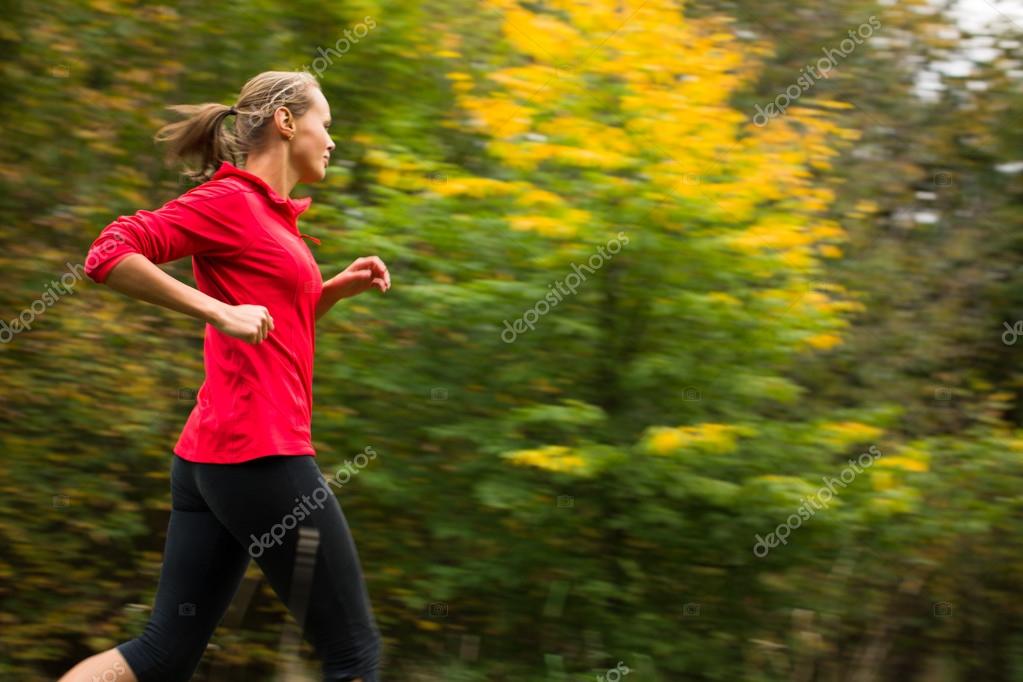 Woman running outdoors in a city park on a cold fall Stock Photo by ...