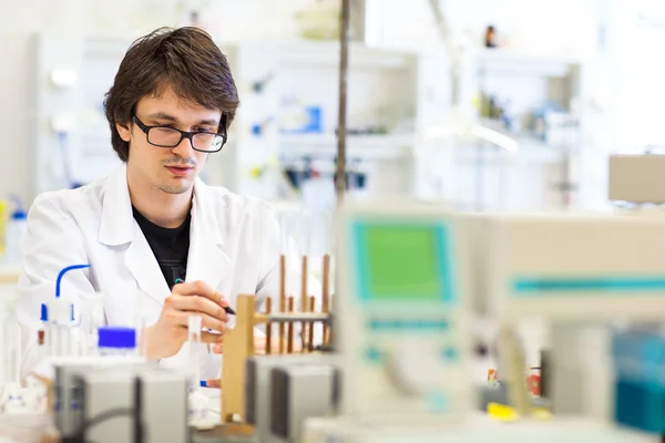 Male researcher carrying out scientific research in a lab - Stock Image ...