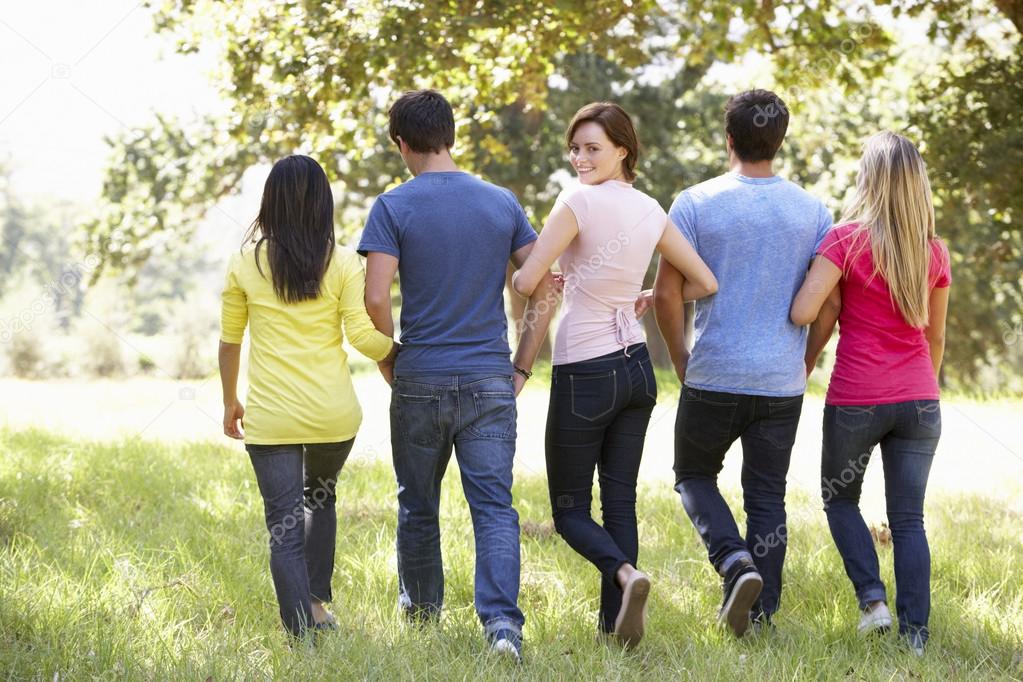 Group Of Friends Walking Through Countryside — Stock Photo ...