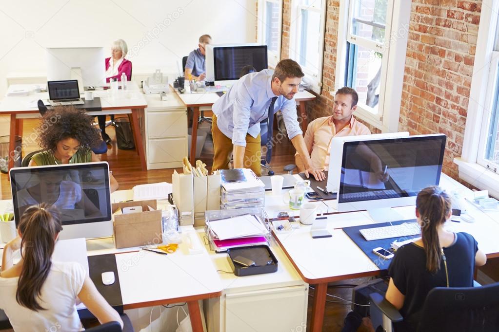 Busy Design Office With Workers At Desks Stock Photo by ©monkeybusiness ...