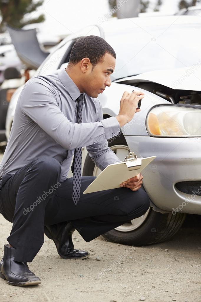 Loss Adjuster Taking Photograph Of Damage To Car Stock Photo by ...