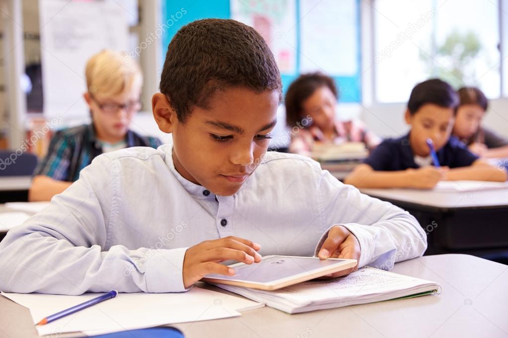 Boy using tablet computer in school class — Stock Photo ...