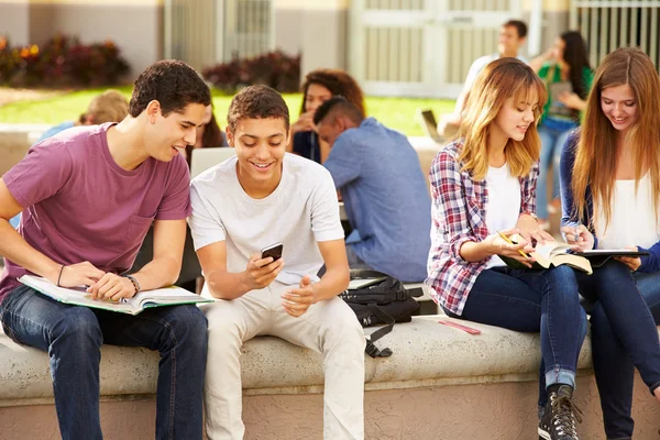 Students Hanging Out On Campus — Stock Photo © monkeybusiness #59346645