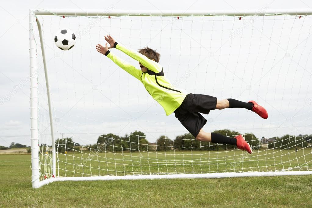 Boy goalkeeper jumping ⬇ Stock Photo, Image by © monkeybusiness #61027851