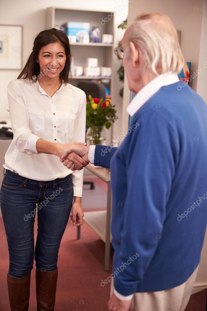 Receptionist Greeting Senior Male Patient — Stock Photo ...
