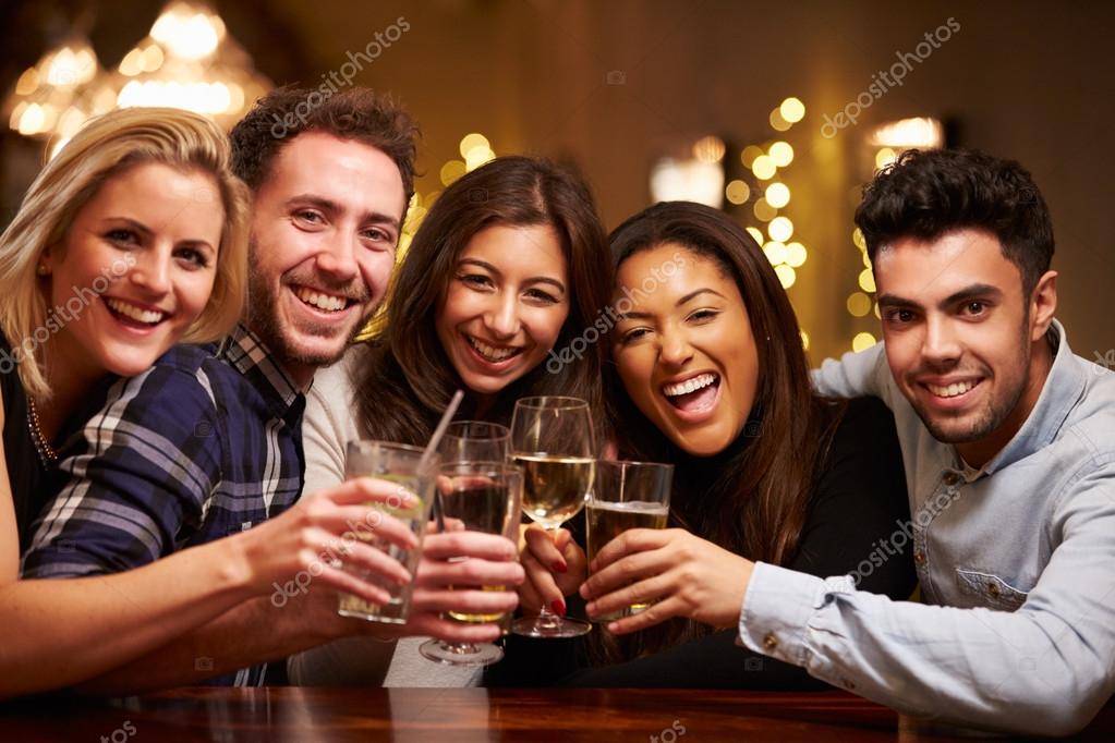 Group Of Friends Enjoying Drinks In Bar — Stock Photo © monkeybusiness ... Group Of Friends Enjoying Drinks In Bar — Stock Photo © monkeybusiness ...