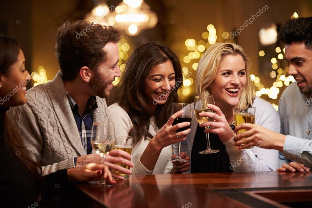 Group Of Friends Enjoying Drinks In Bar — Stock Photo © monkeybusiness ... Group Of Friends Enjoying Drinks In Bar — Stock Photo © monkeybusiness ...