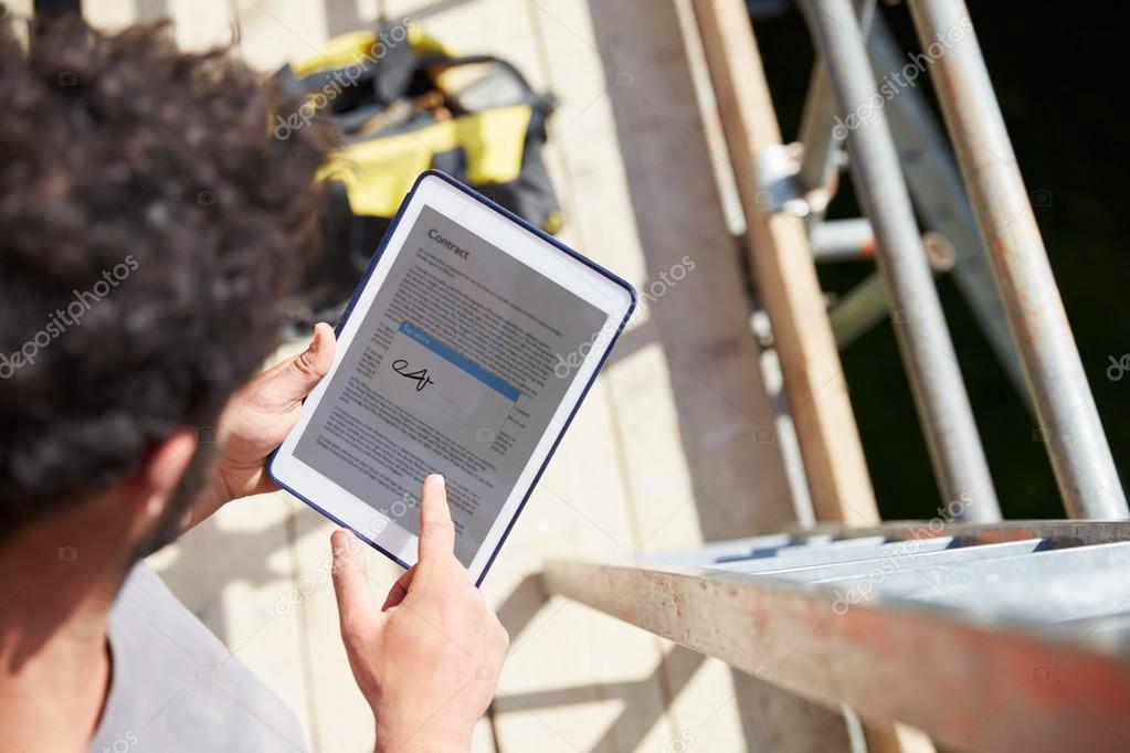 Construction Worker Signing Contract — Stock Photo © monkeybusiness ...