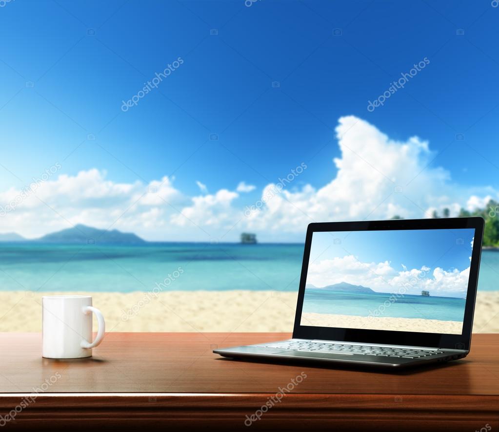 Notebook on table and tropical beach — Stock Photo © Iakov #51893281