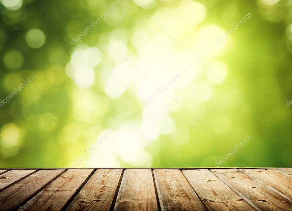 Wooden surface and sunny forest — Stock Photo © Iakov #62638183