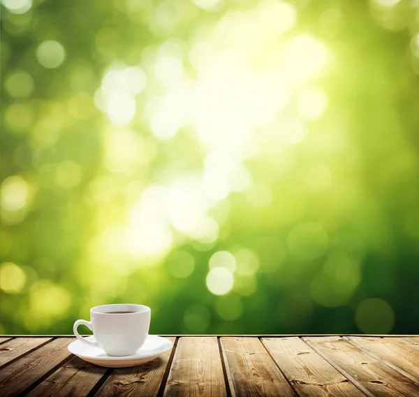 cup coffee and sunny trees background — Stock Photo © Iakov #53761391