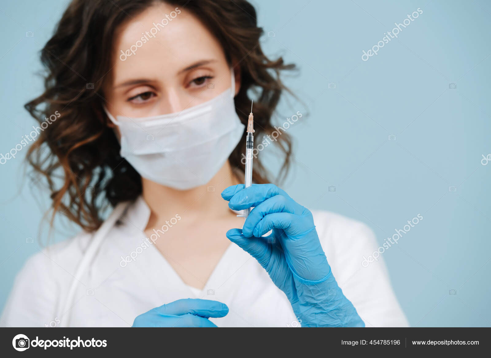 Careful nurse pushing air out of syringe for vaccine injection. Over ...