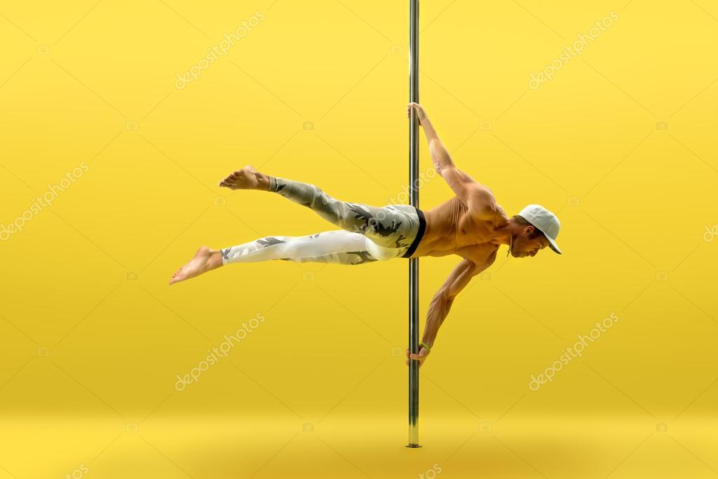 Studio photo of acrobat exercising on pole — Stock Photo © Wisky #121281228