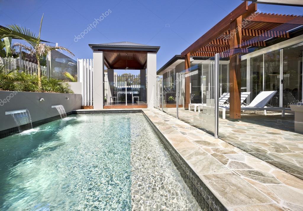 Modern swimming pool side with glass cover and wooden patio — Stock ...
