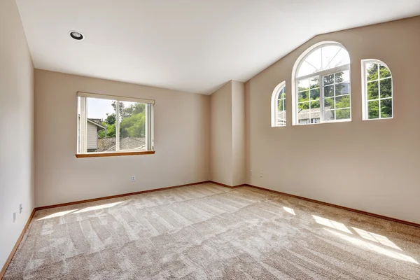 Empty master bedroom with window and high vaulted ceiling - Stock Image ...